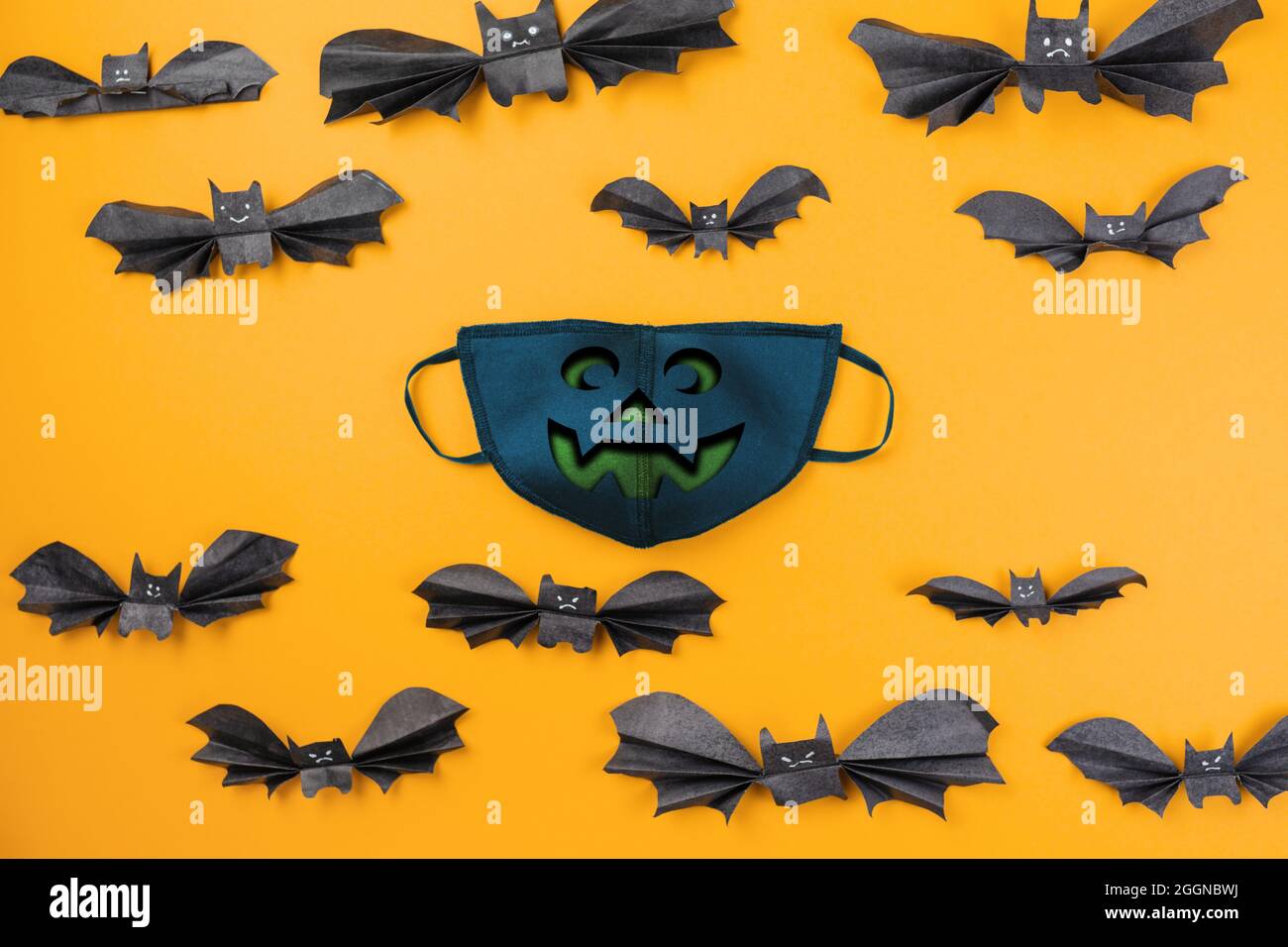 Reusable anti-virus mask with print of jack lantern surrounded by paper ...