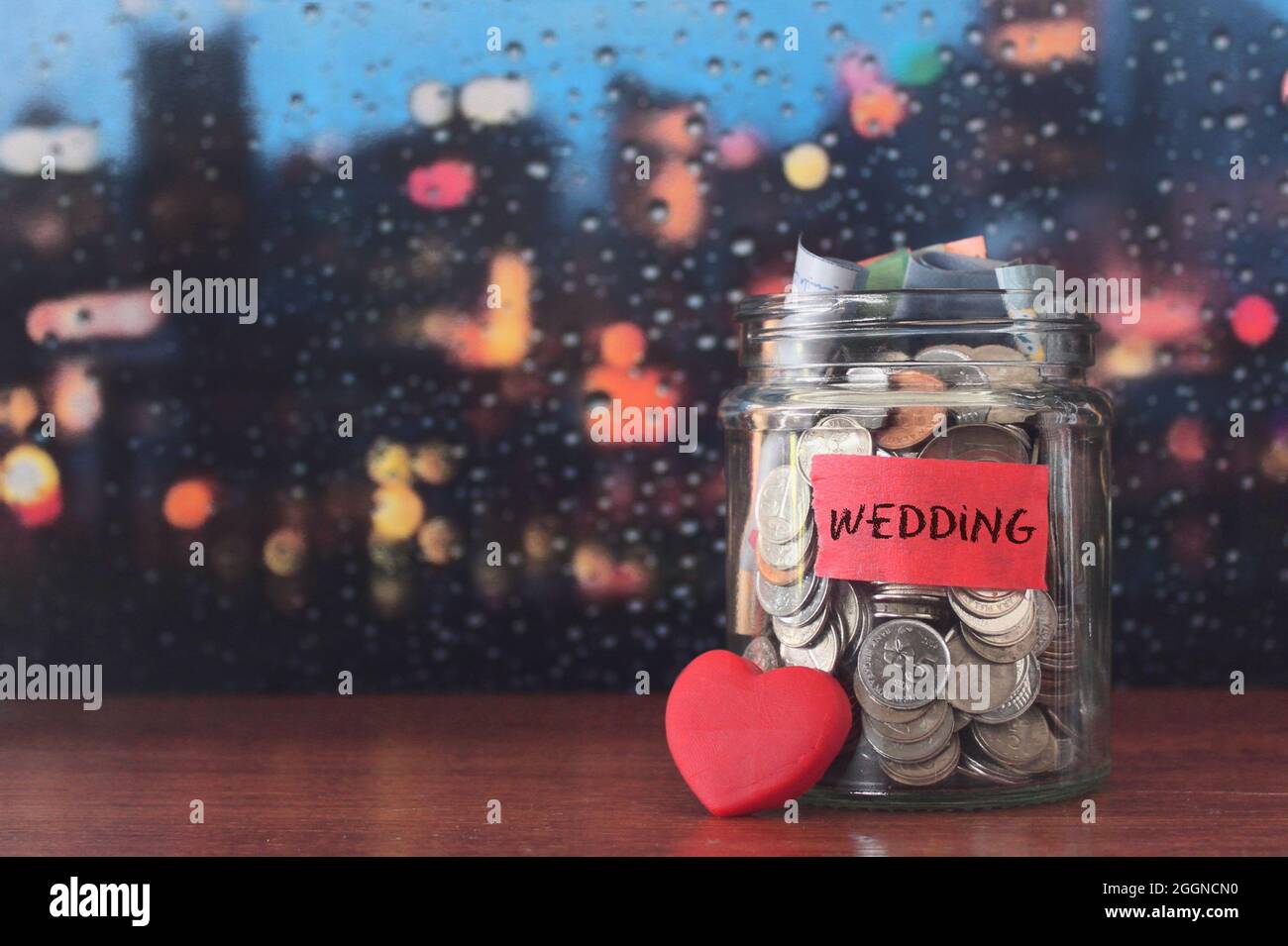 Wedding budget, saving money for wedding concept. Coins in a glass jar ...