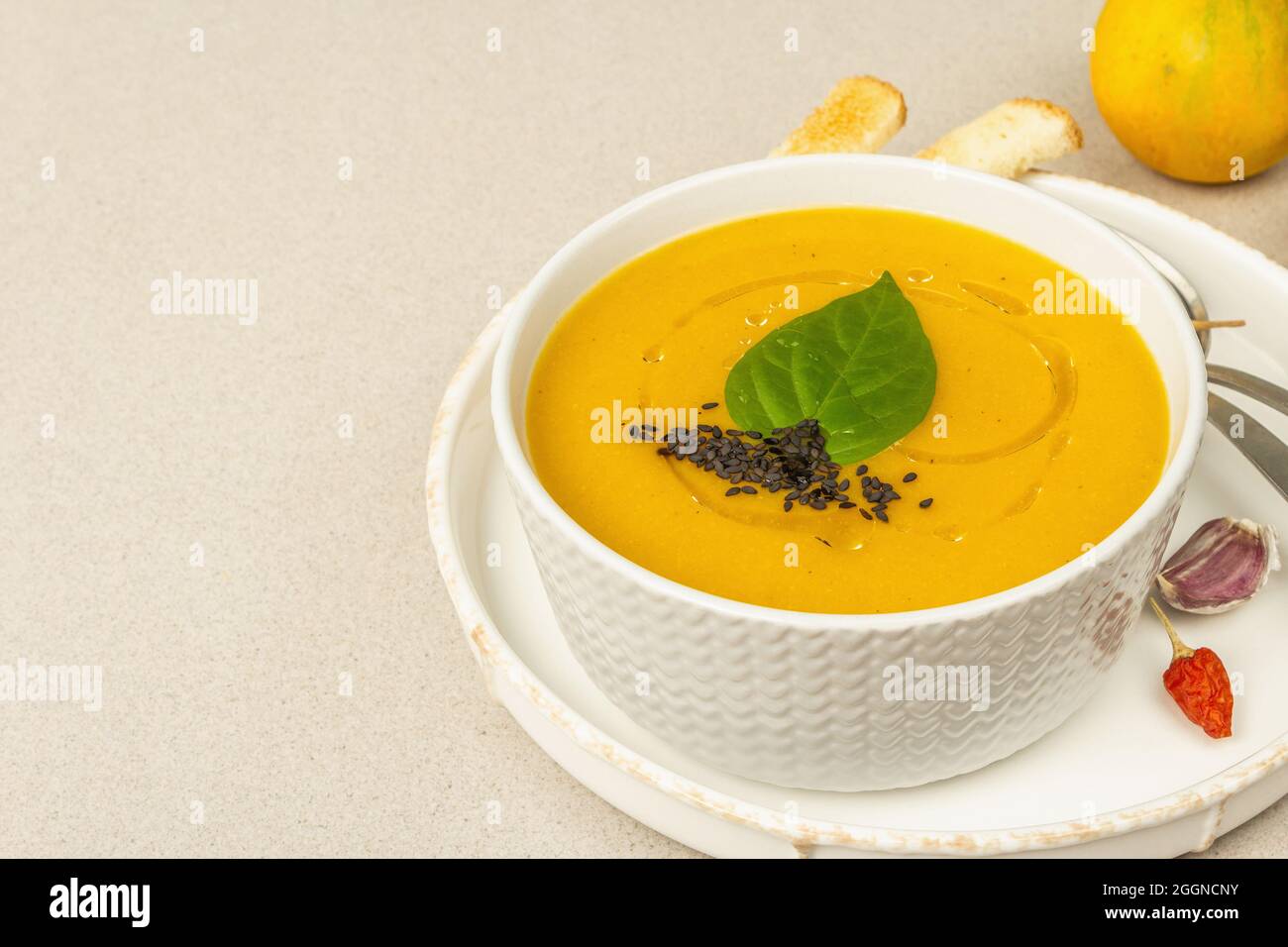 Pumpkin cream soup. Traditional autumn food. Hot dish, ripe vegetables ...