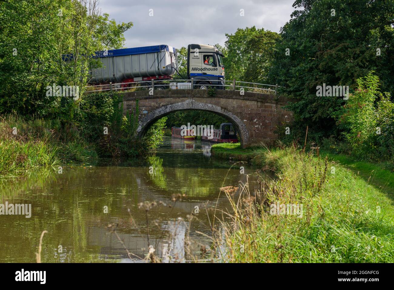 Tipper lorry crossing the Lancaster canal by a narrow bridge Stock ...