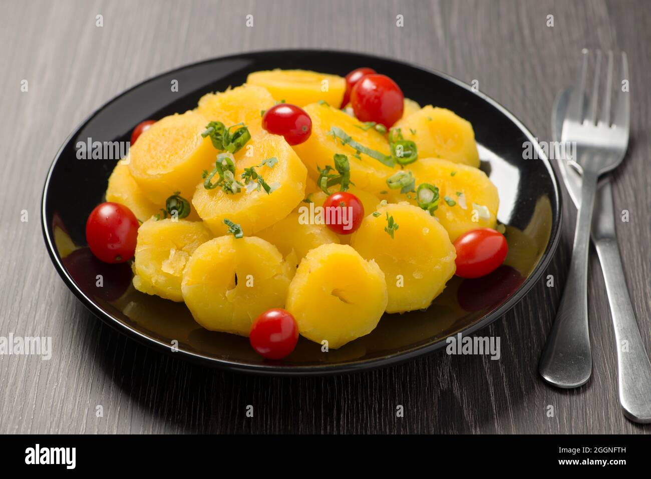cooked cassava with cherry tomato Stock Photo - Alamy