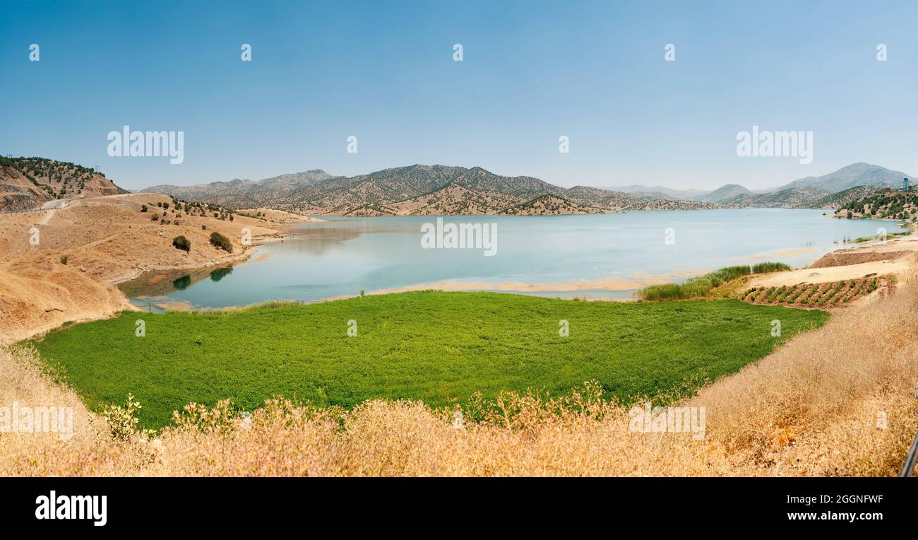 the view of water in a lake with mountains surrounded with clear blue ...