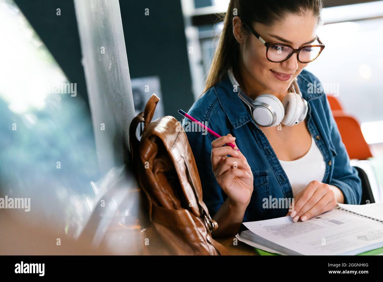 Beautiful student girl studying, reading book at home Stock Photo - Alamy