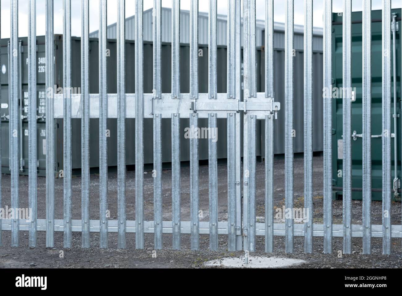 Security gate entrance locked with a padlock and sliding bolt Stock ...