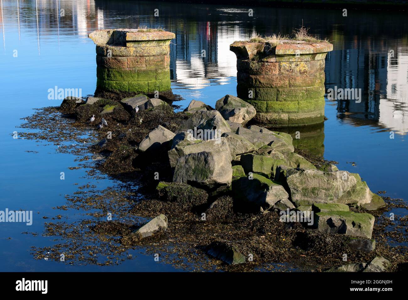 Abandoned and dilapidated bridge piers in a river estuary Stock Photo ...