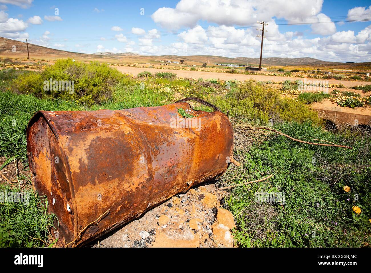 Forgotten Industry: Rusted Oil Barrel in an Open Field Stock Photo - Alamy