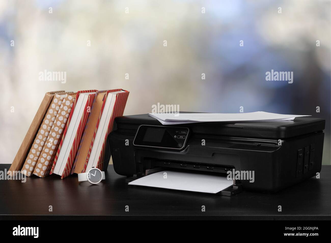 Stack of books and home printer against blurred background Stock Photo ...