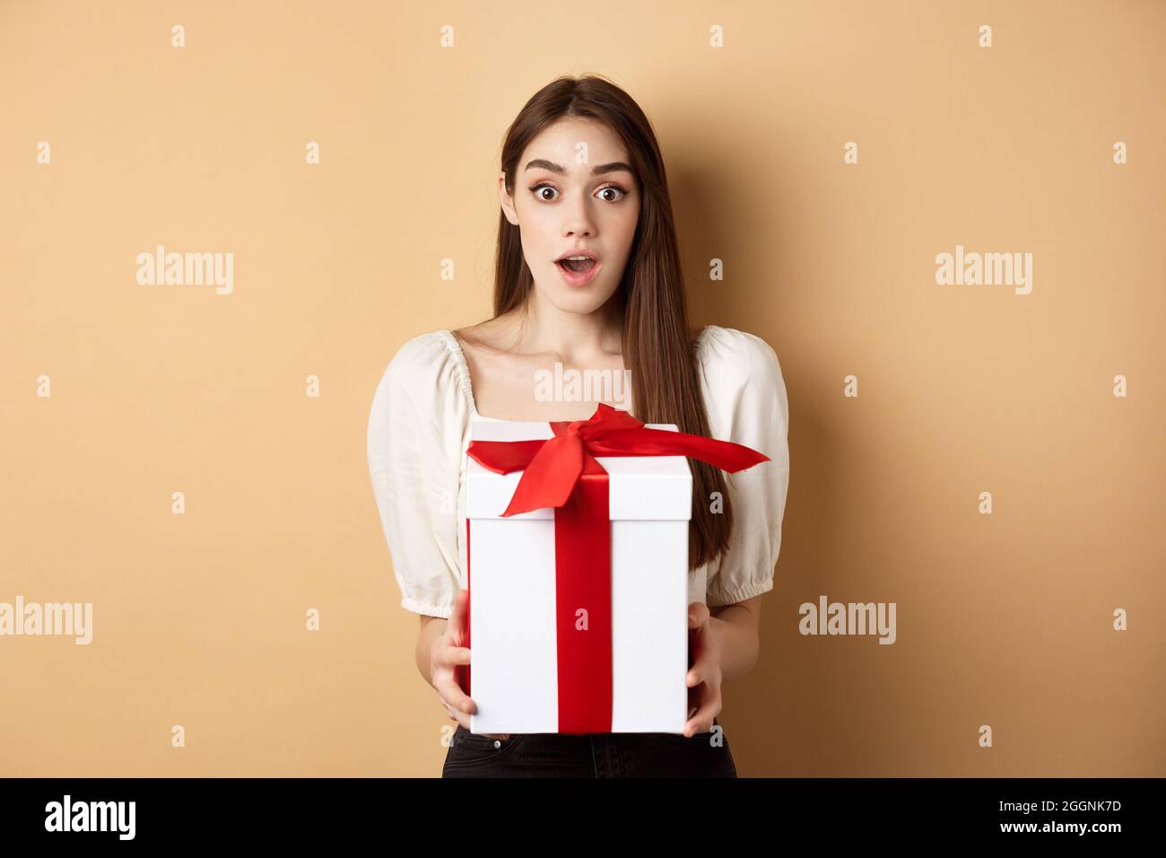 Amazed beautiful girl receiving gift from secret admirer on Valentines ...