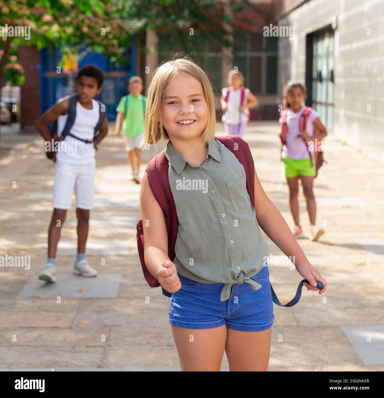 Cheerful preteen girl with backpack going to school on summer day Stock ...