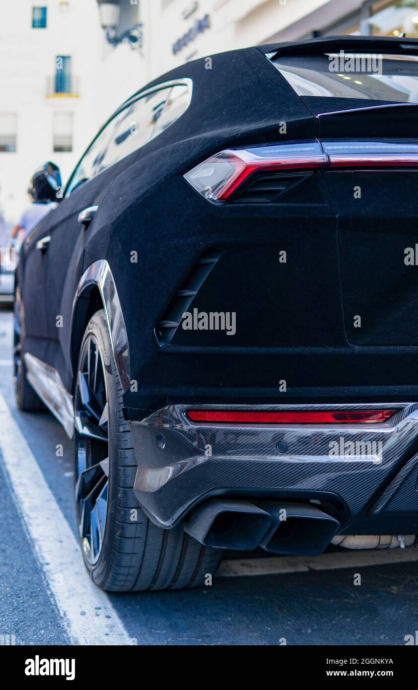Rear view of a black modern sport car on city beach background Stock ...