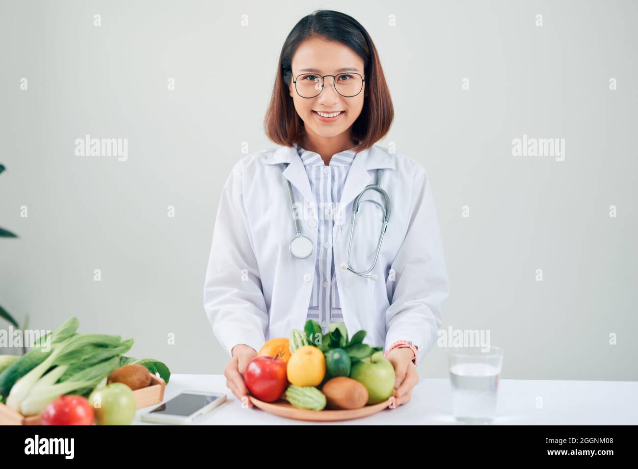 Nutritionist desk with healthy fruits, juice and measuring tape ...