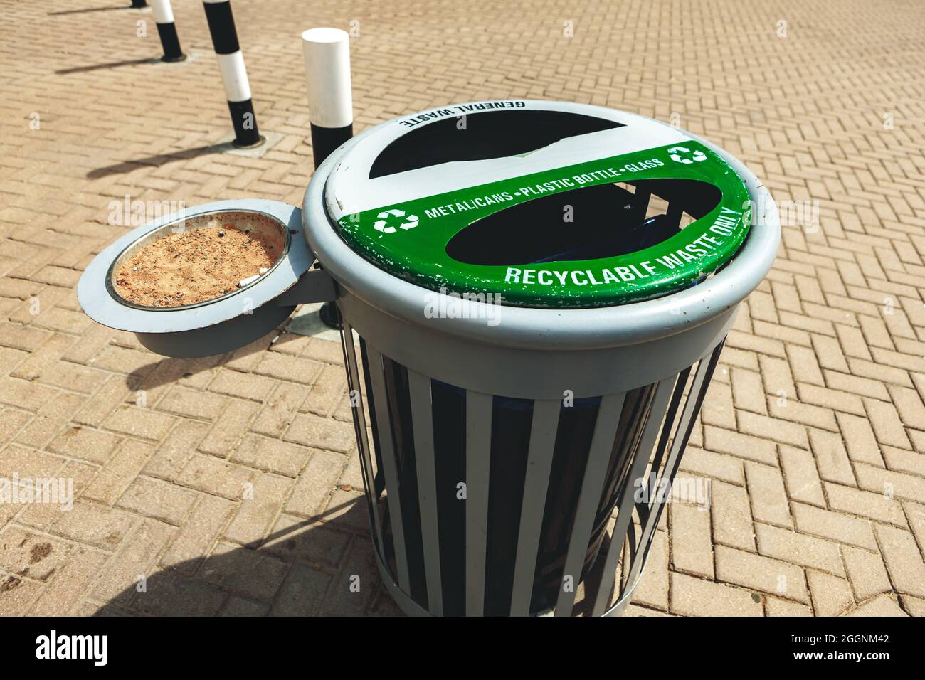 Outdoor public garbage bin with compartments for general and recycling ...