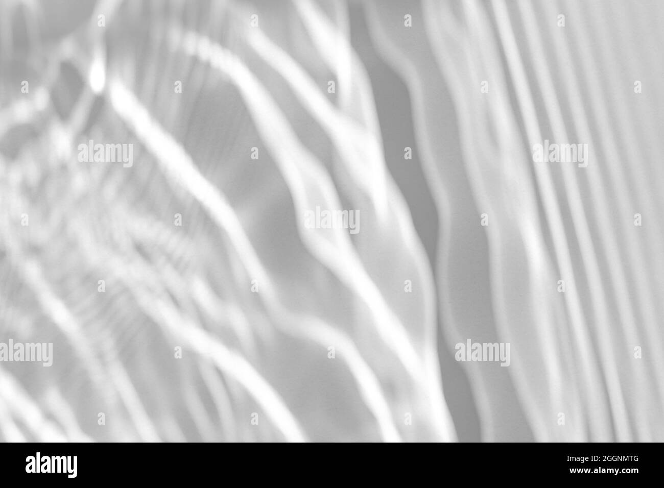 blurred shadow and light caustic effect on a white wall Stock Photo - Alamy