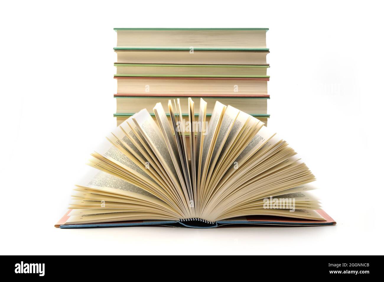 Stack of books with one book open on white background. A stack of books ...