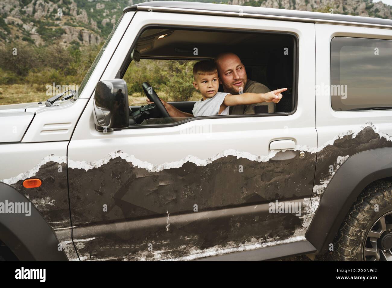 Father teaches little son to drive on road trip Stock Photo - Alamy