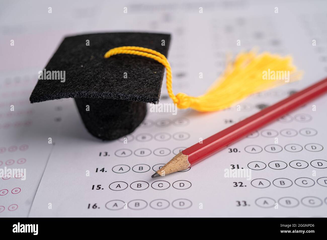 Graduation gap hat and pencil on answer sheet background, Education ...