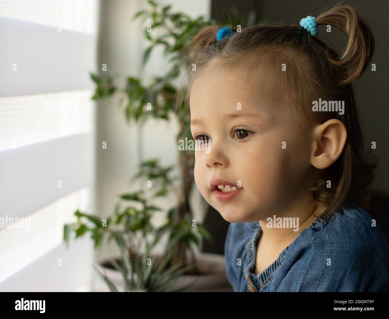 Little cute girl 1-3 near the window Stock Photo - Alamy