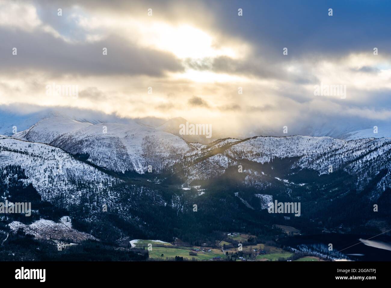 Beautiful landscape with a valley surrounded by snowy mountains. Volda ...