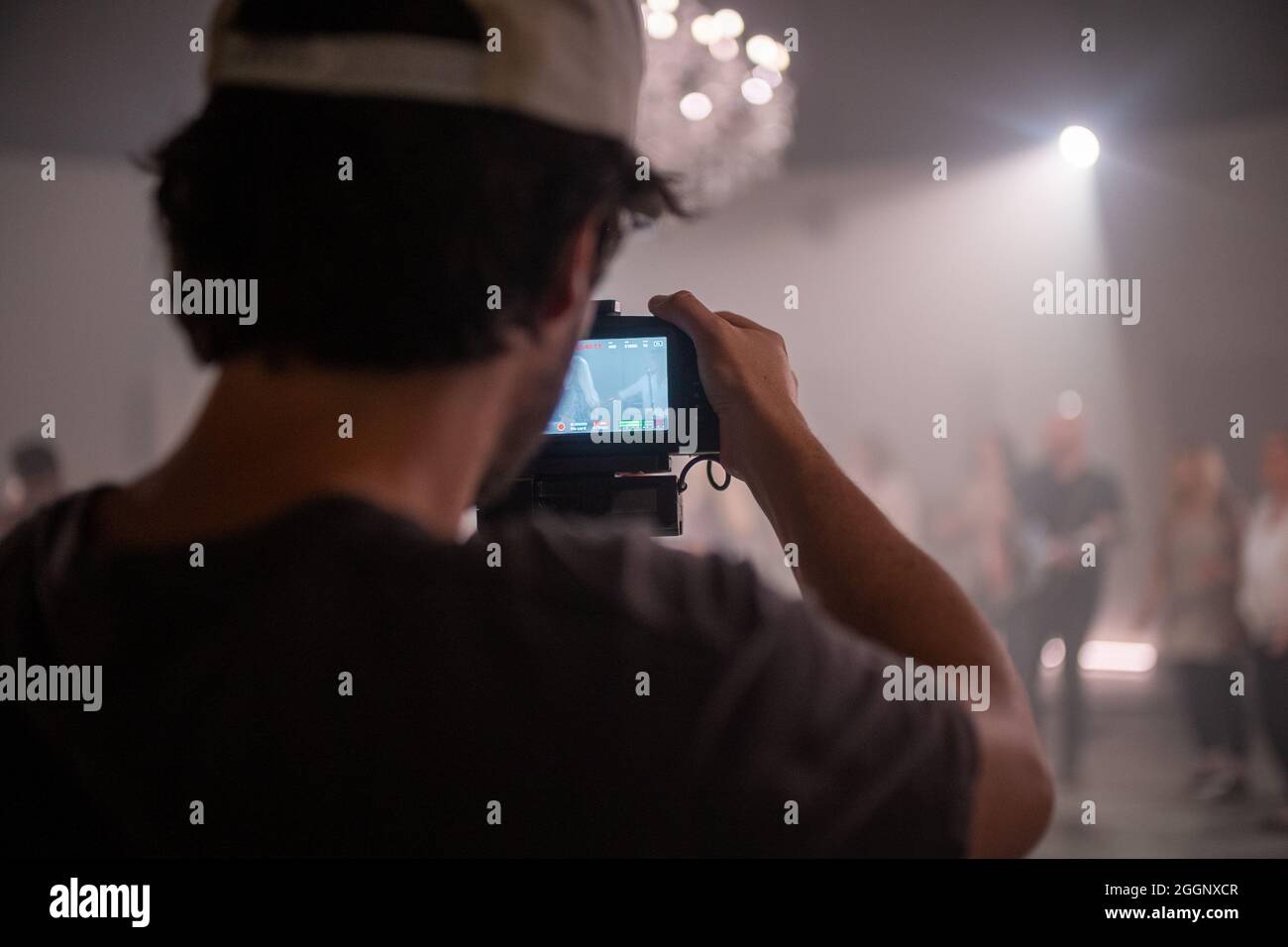Rear view of cameraman holding a camera on a studio Stock Photo - Alamy
