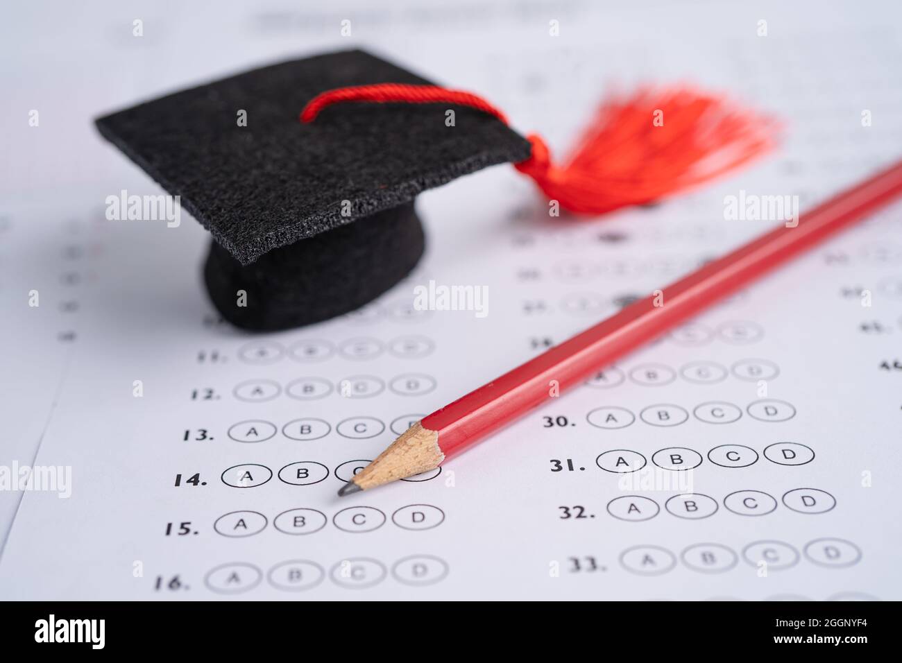 Graduation gap hat and pencil on answer sheet background, Education ...