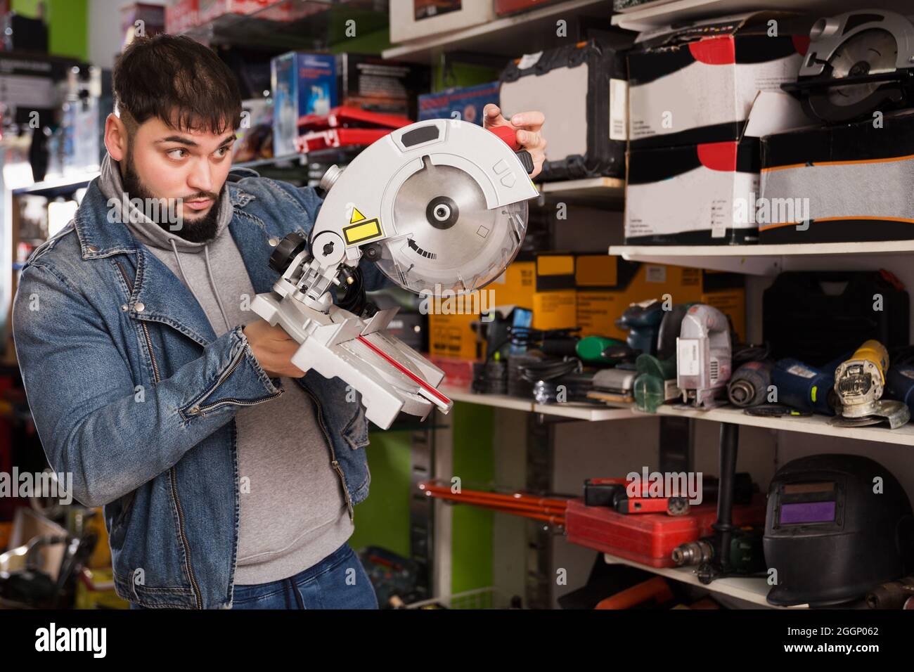 male engineer chooses circular saw in tool store Stock Photo - Alamy