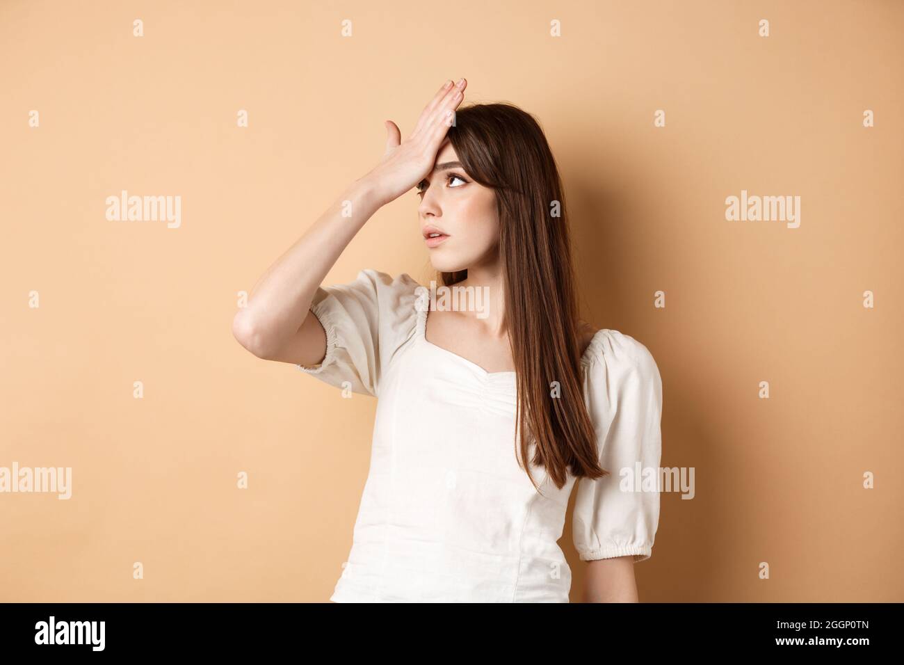 Girl rolling her eyes and slap forehead annoyed, bothered by something ...