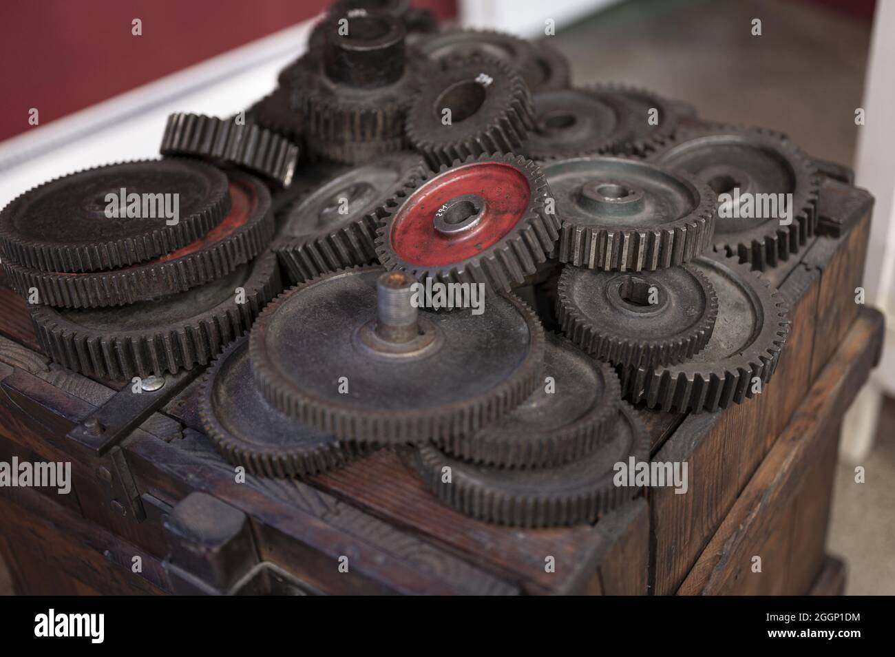 Pile of gears stacked on top of a wooden box Stock Photo - Alamy