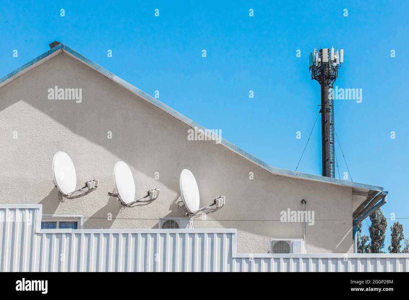 Satellite TV white dishes antenna signal and communications on the wall ...