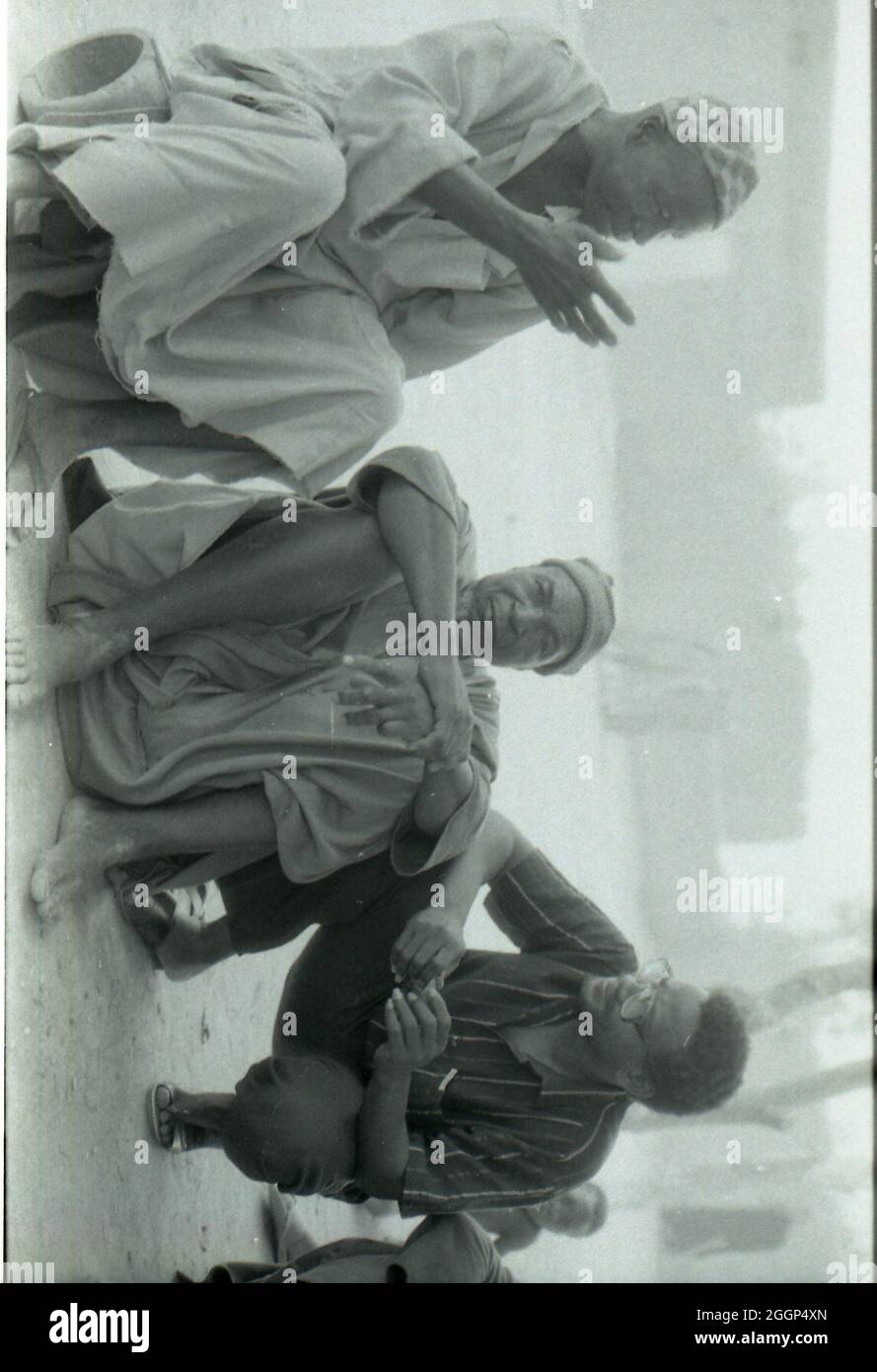 A group of men sitting down - talking to each other Stock Photo - Alamy