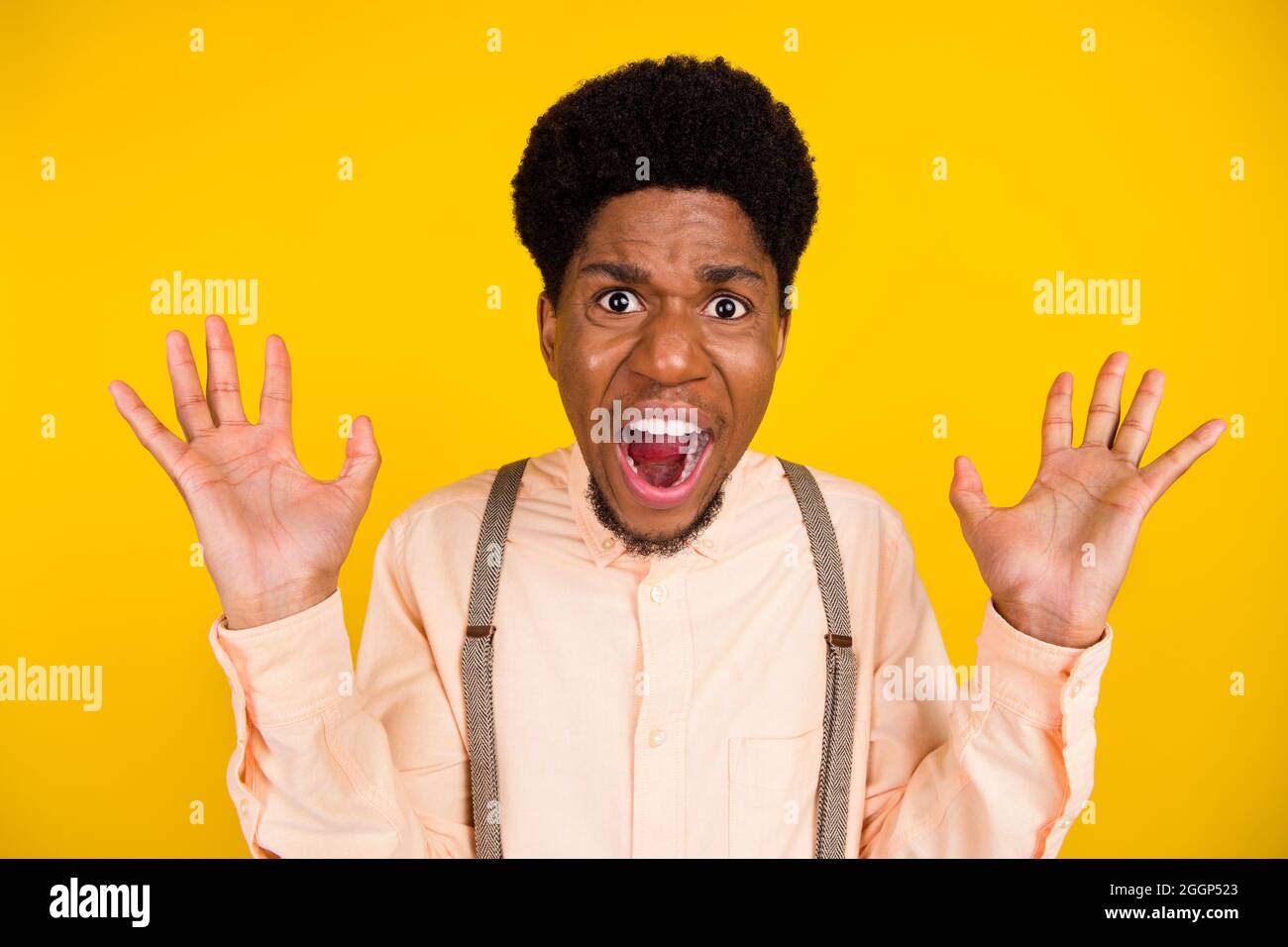 Photo of mad outraged furious guy scream open mouth wear suspenders ...