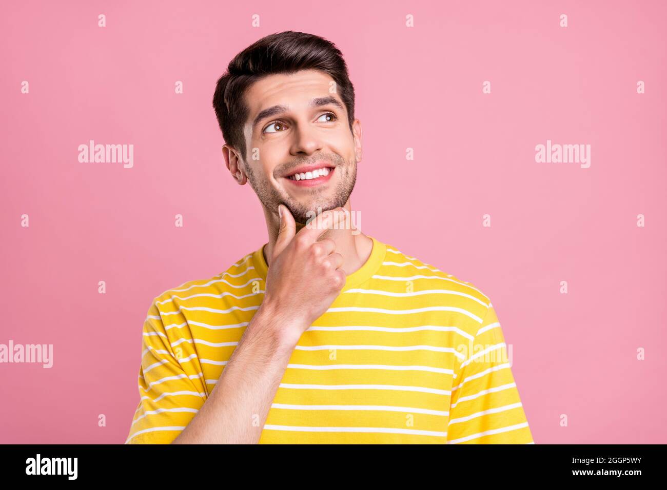 Portrait of attractive dreamy cheerful minded guy touching chin ...