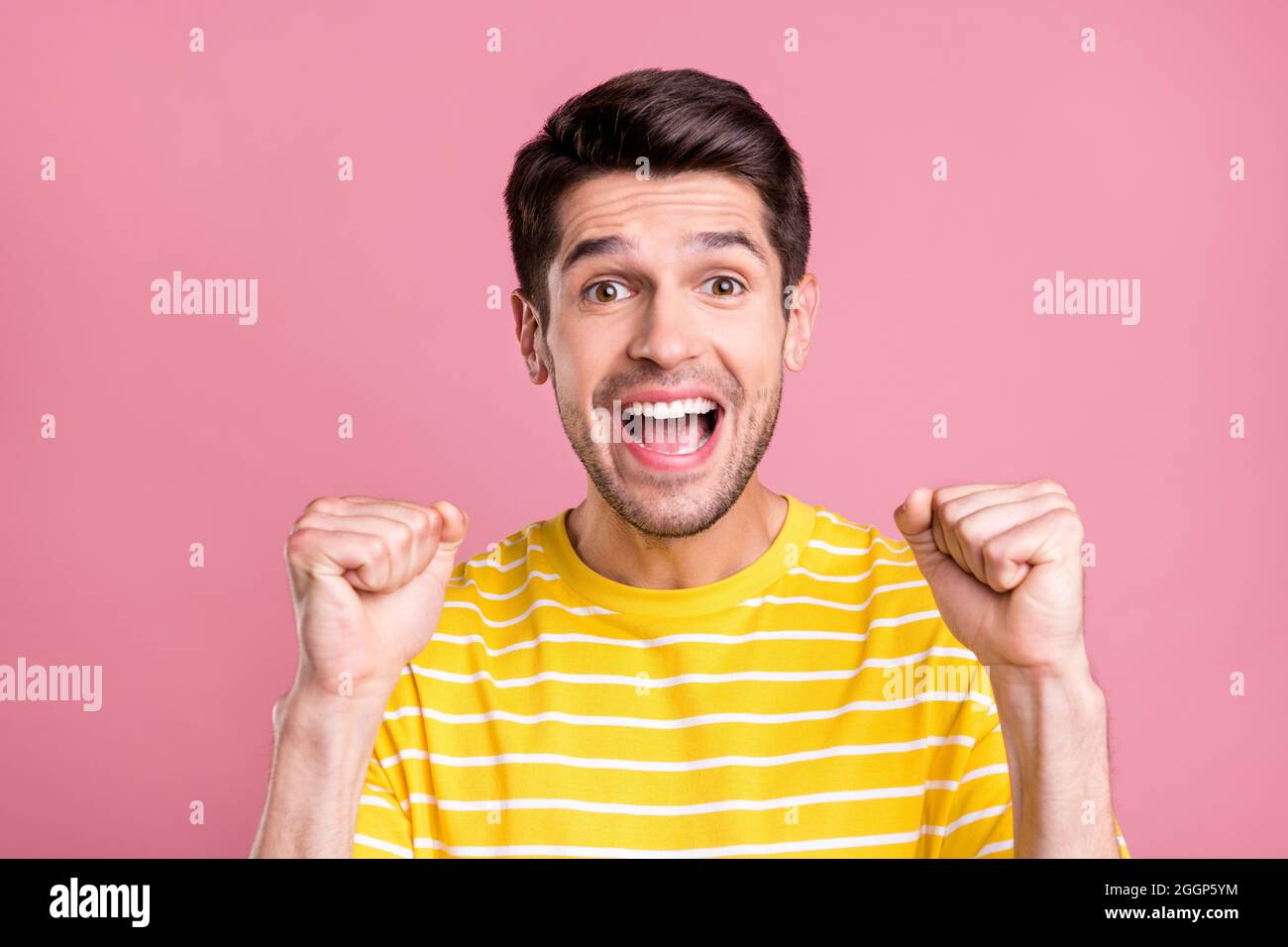 Portrait of attractive lucky cheerful brunette guy celebrating having ...