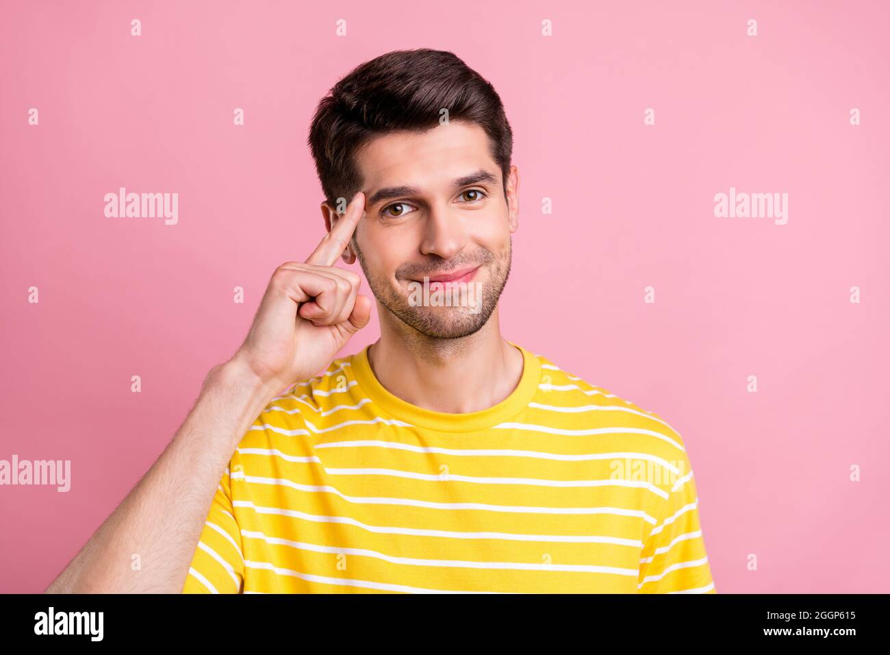 Portrait of attractive minded cheerful guy touching temple making ...