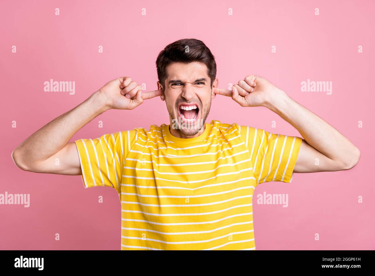 Portrait of attractive crazy fury guy yelling closing ears fight break ...
