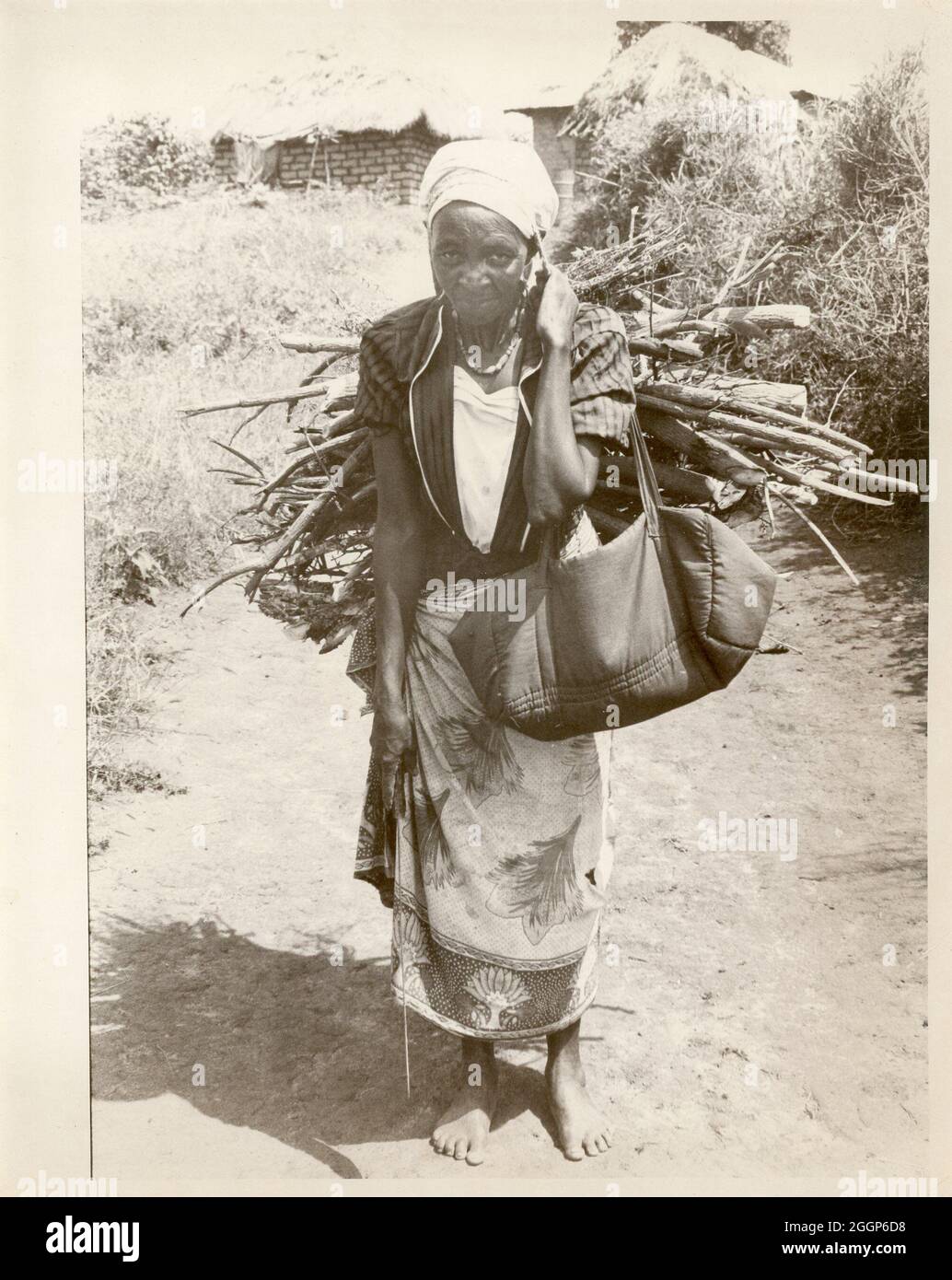 An older woman carrying tree branches Stock Photo - Alamy