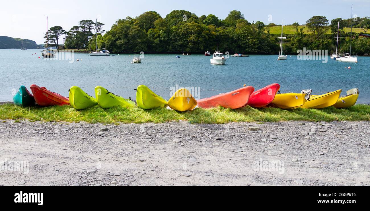 Coloured Kayak Bows lined up on waters edge Stock Photo - Alamy