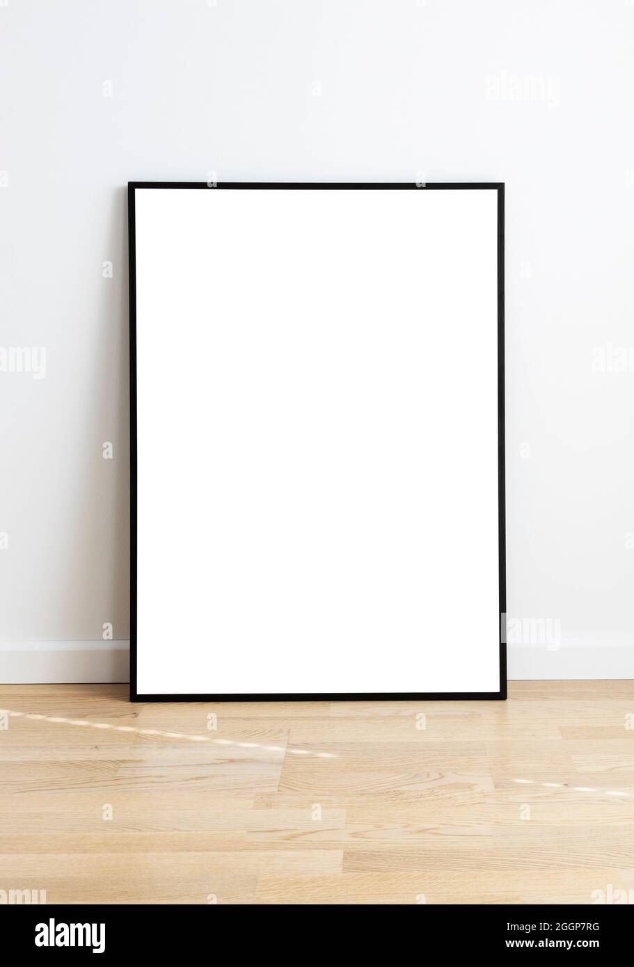 Rectangular mock up standing in a room with wooden flooring and white ...