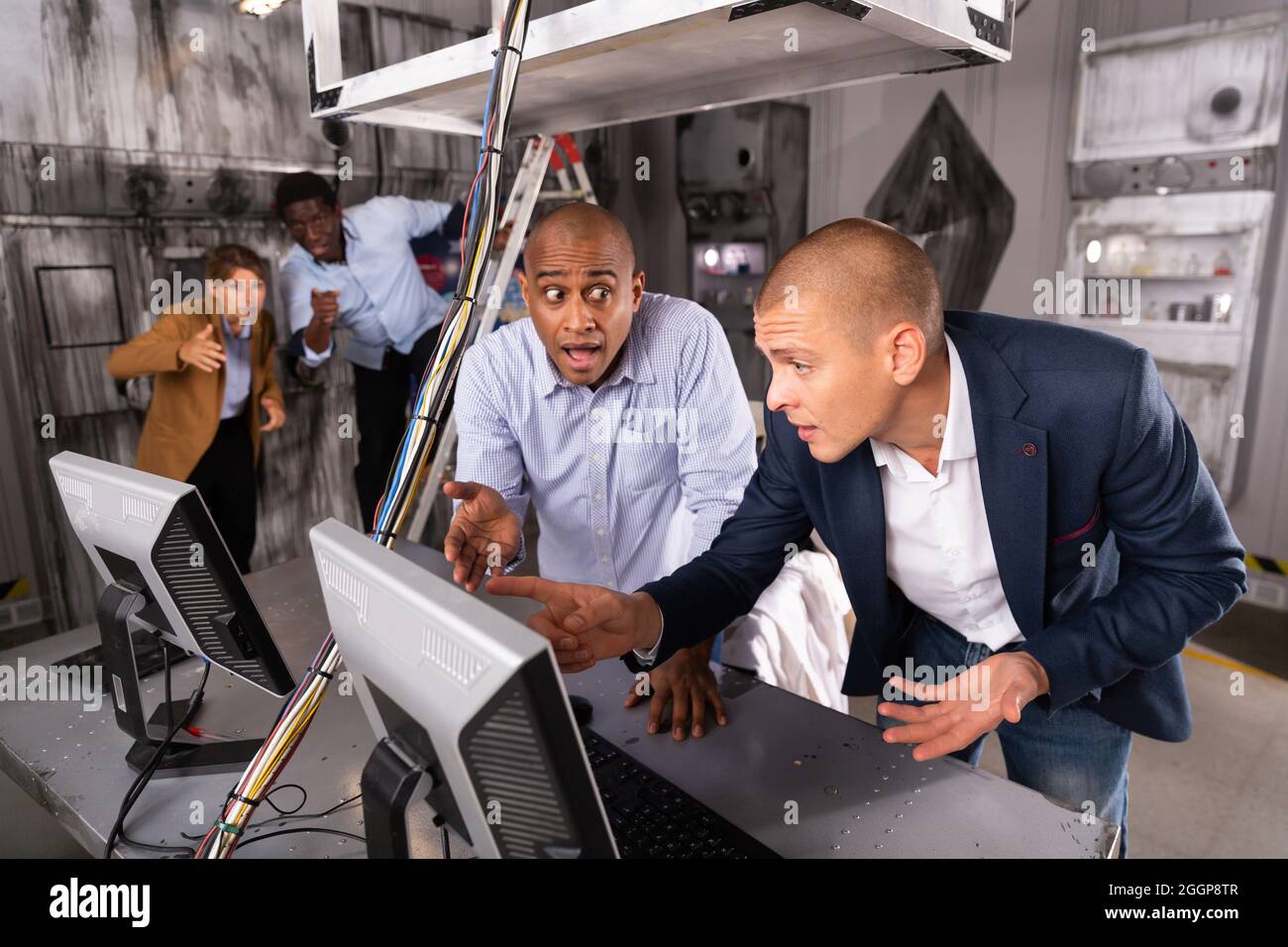 Two men solving puzzle in escape room Stock Photo - Alamy