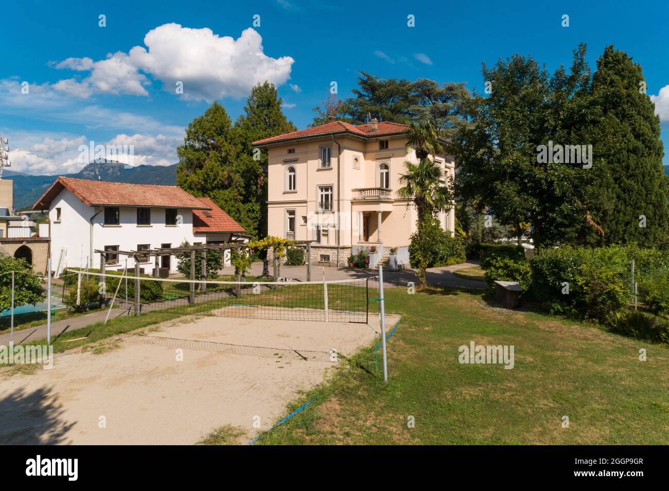 Large and old villa with large garden around it on a sunny summer day ...