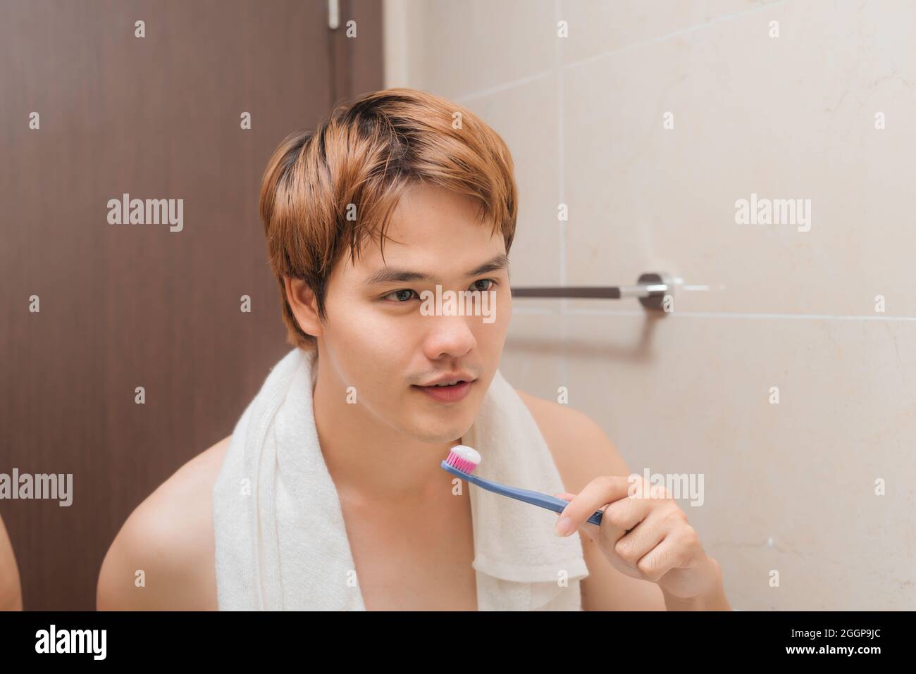 Asian man brushing teeth in the morning in bathroom Stock Photo - Alamy