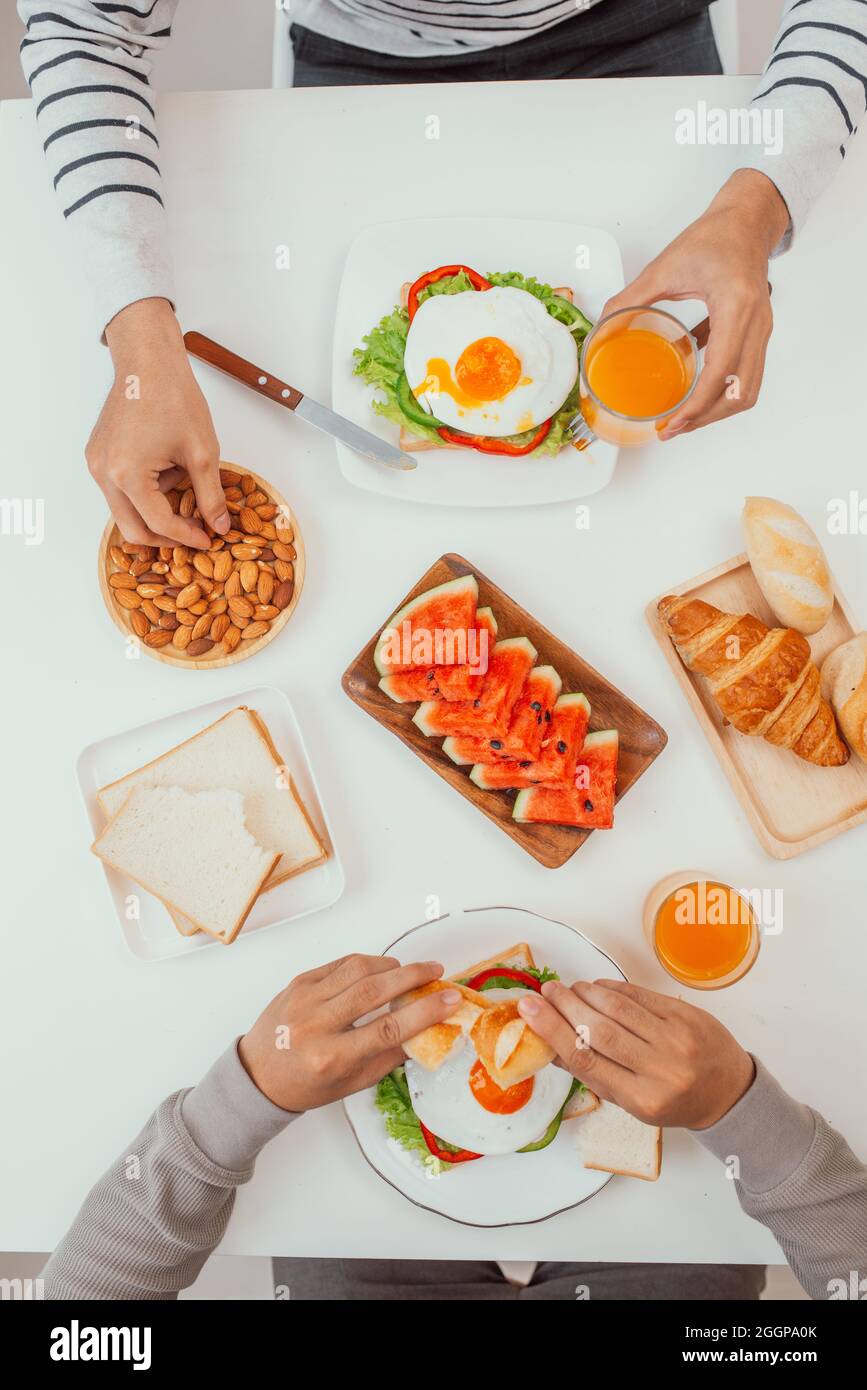 Young Happy Family Having Breakfast Stock Photo - Alamy