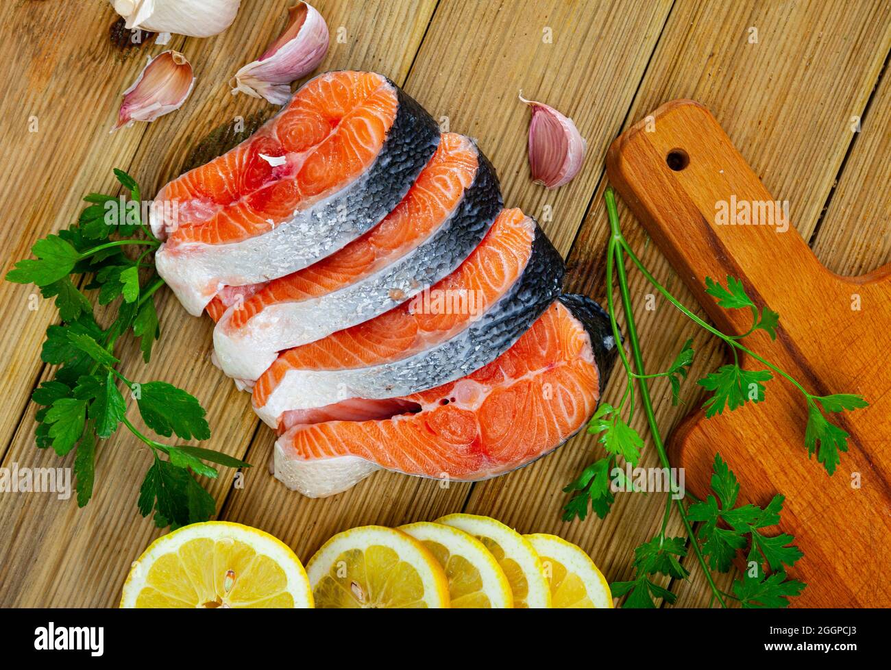 Raw seafood, fresh fillet salmon fish on board Stock Photo - Alamy