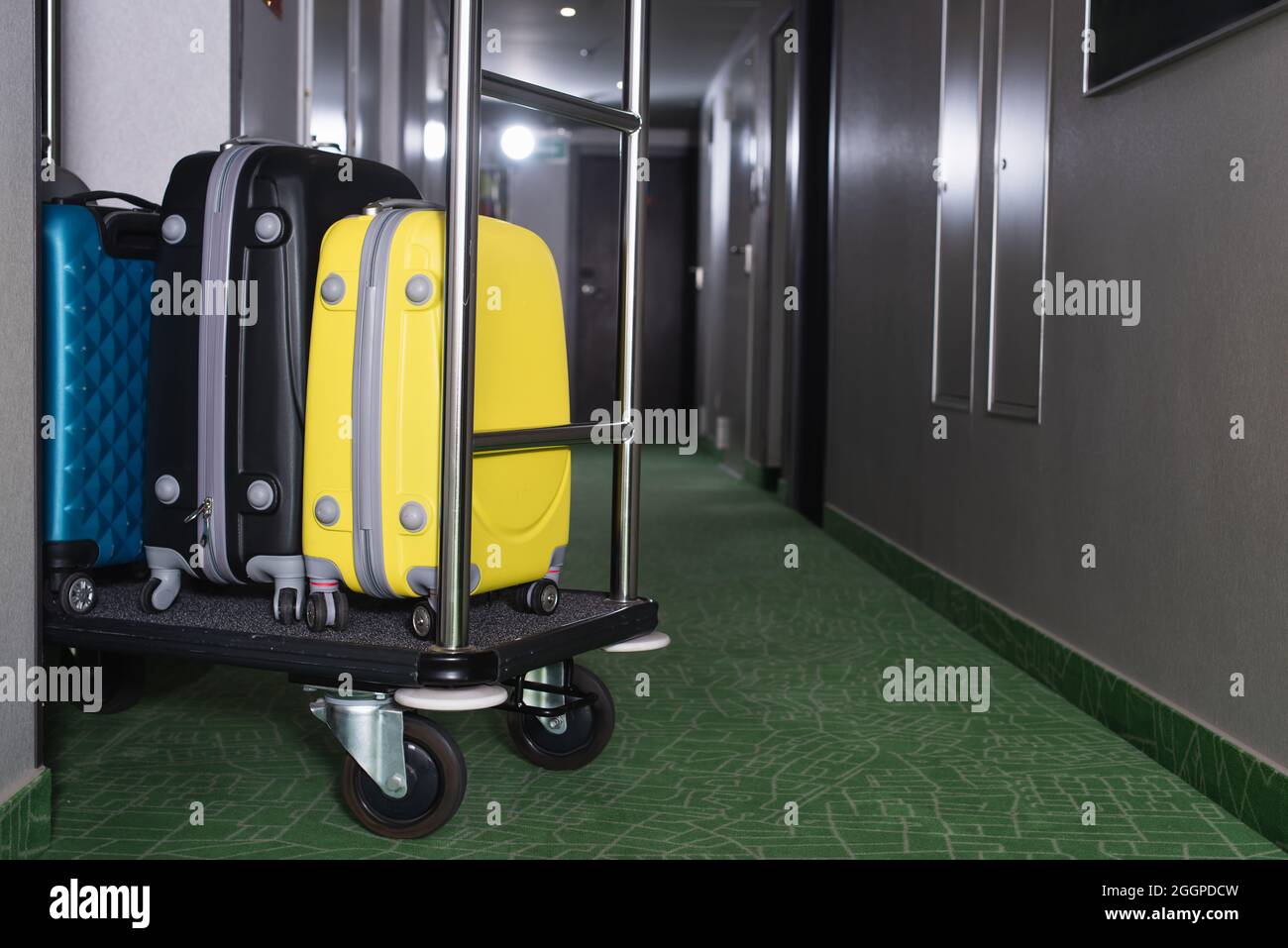 modern luggage on bell cart in hotel hall Stock Photo - Alamy