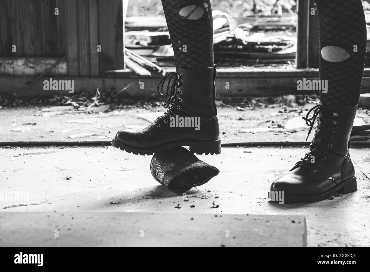 Grayscale of a woman's feet rolling an object Stock Photo - Alamy