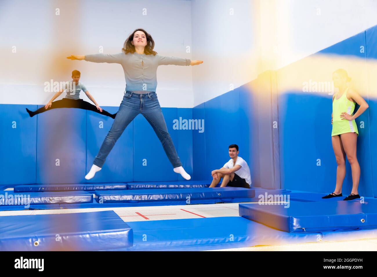 Young people jumping on trampolines Stock Photo - Alamy