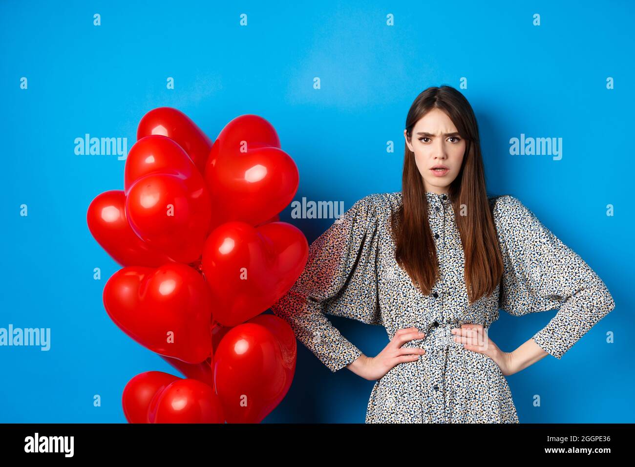 Valentines day. Angry and confused girlfriend in dress, standing near ...