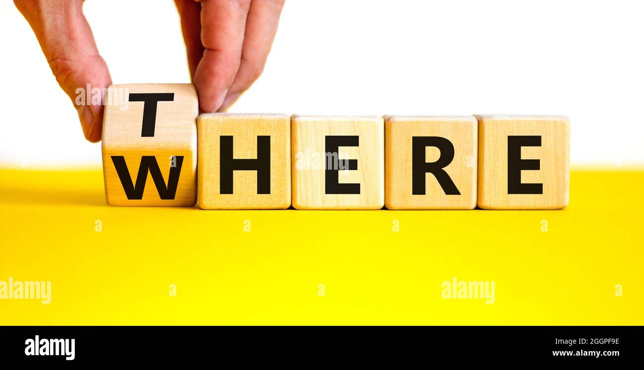 There or where symbol. Businessman turns a wooden cube, changes the ...