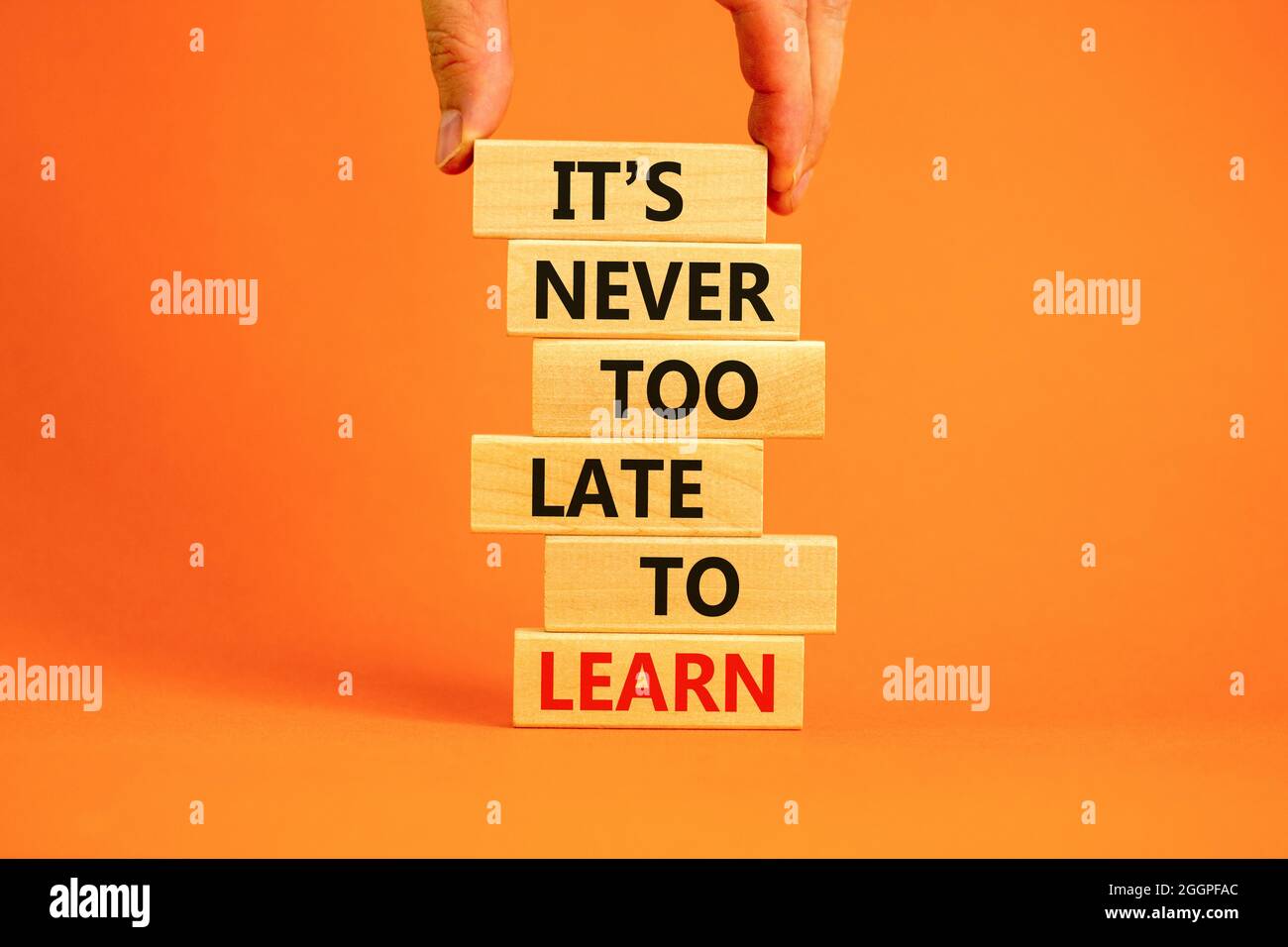 Learn symbol. Wooden blocks with words 'It is never too late to learn ...