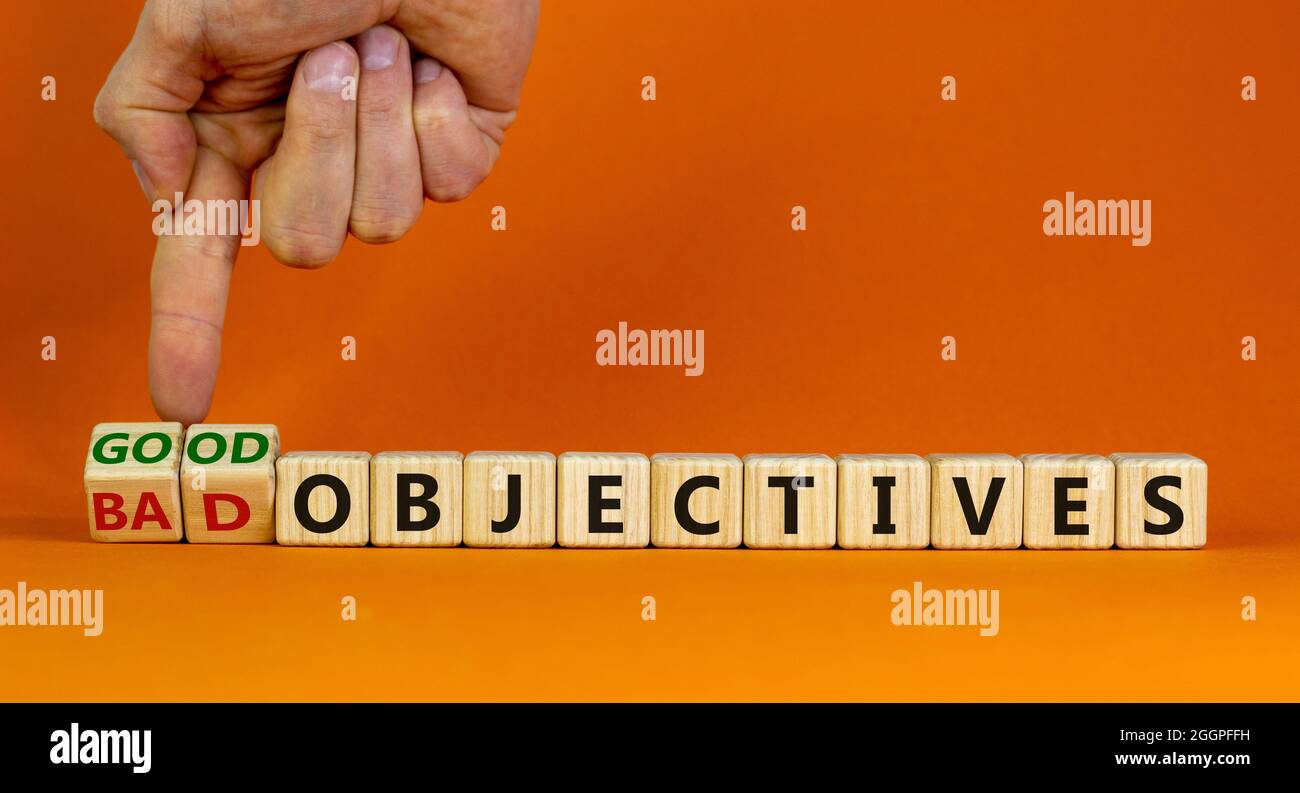 Good or bad objectives symbol. Businessman turns wooden cubes, changes ...