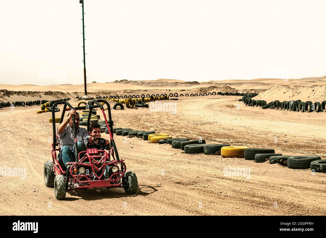 Yazd, Desert, Iran, February 20, 2021: A little boy sits behind the ...